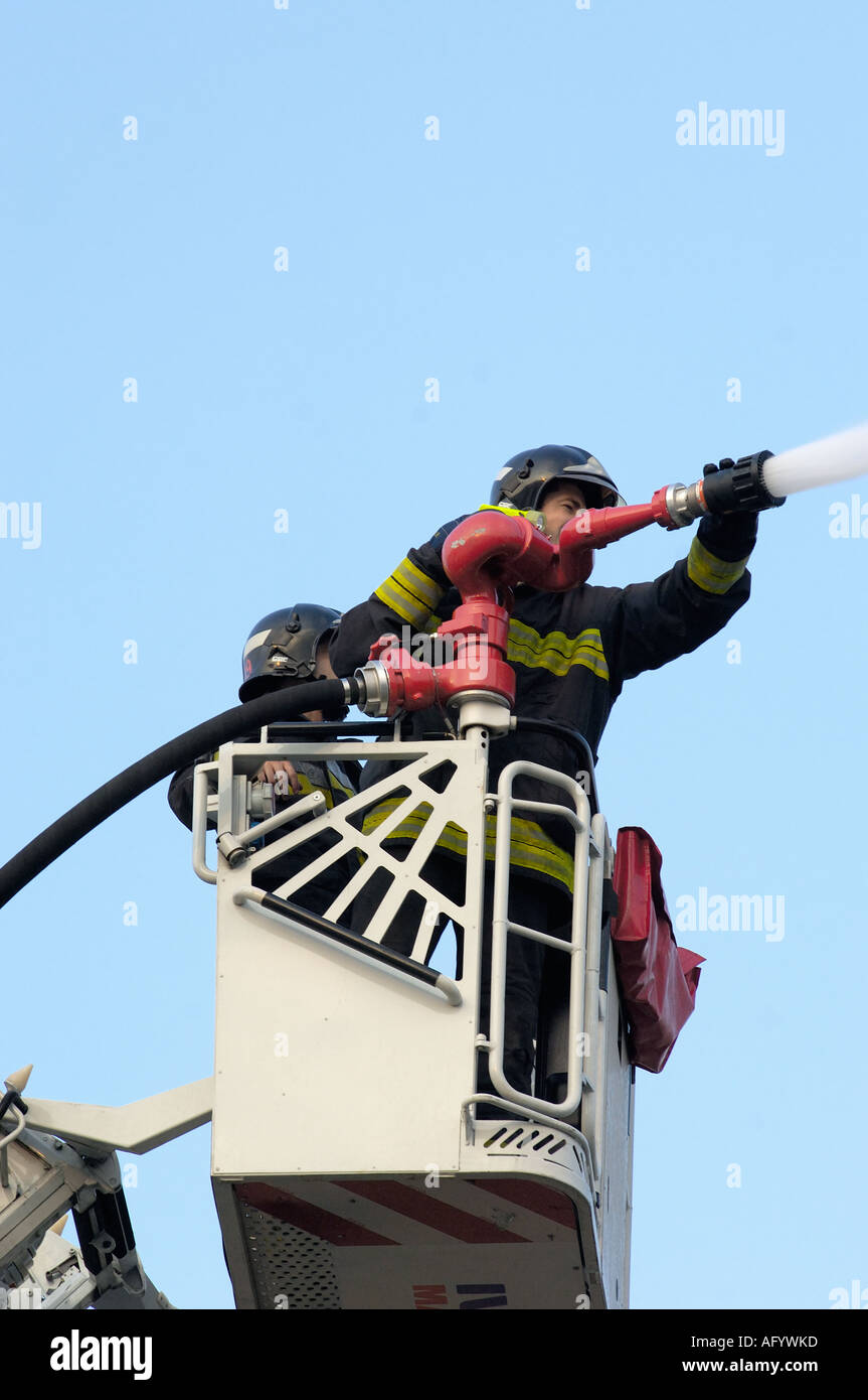 Firemen using water cannon Stock Photo - Alamy