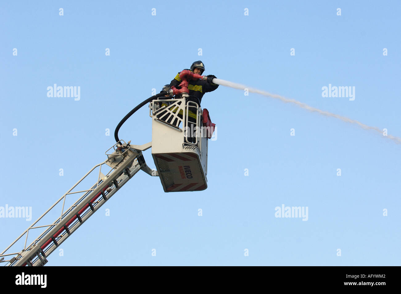 Firemen using water cannon Stock Photo - Alamy