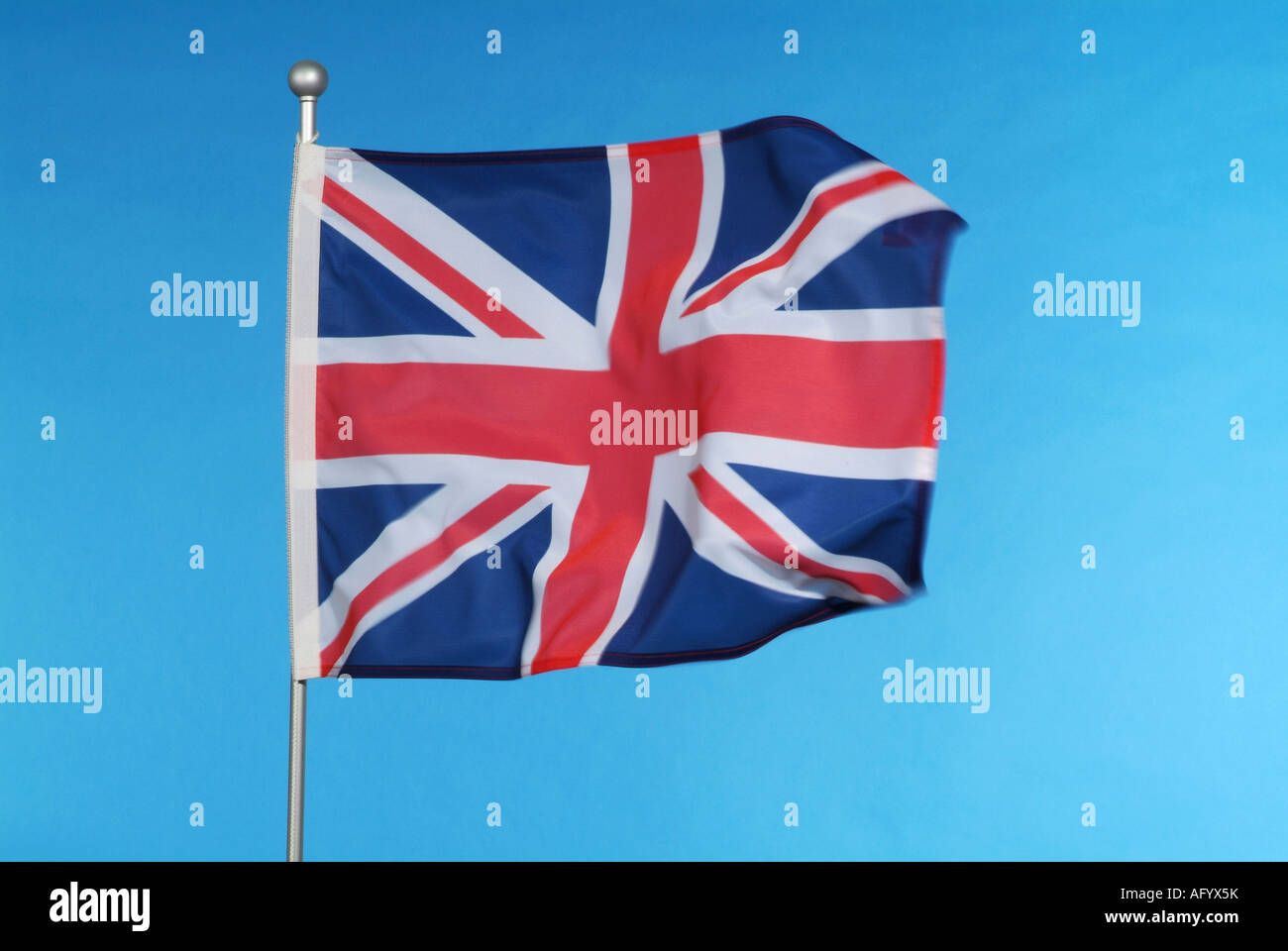 British national flag against blue sky Stock Photo - Alamy