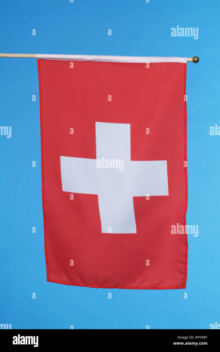 Swiss national flag against blue sky Stock Photo - Alamy