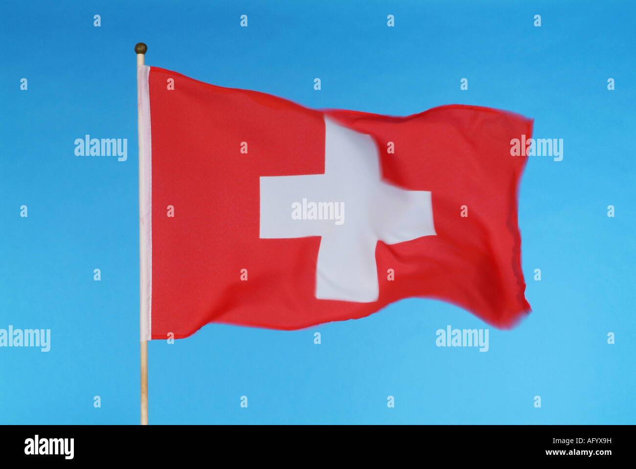 Swiss national flag against blue sky Stock Photo - Alamy