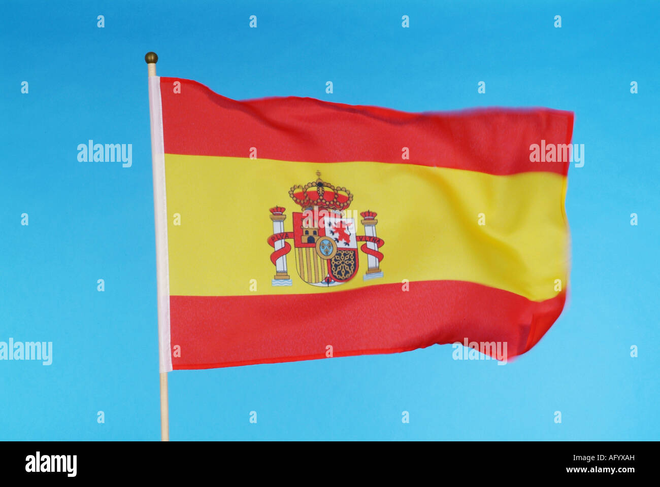 Spanish national flag against blue sky Stock Photo - Alamy