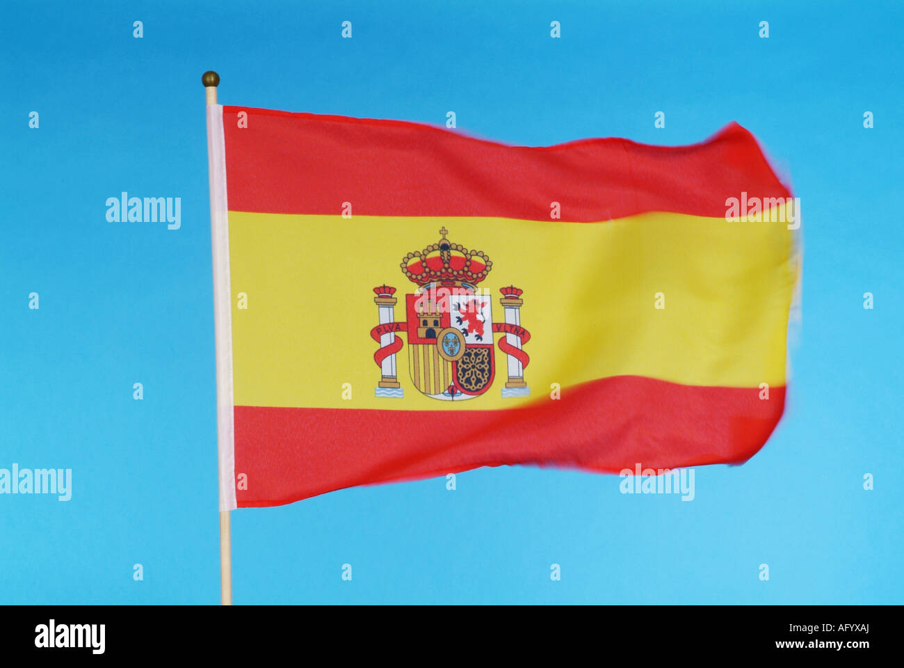Spanish national flag against blue sky Stock Photo - Alamy