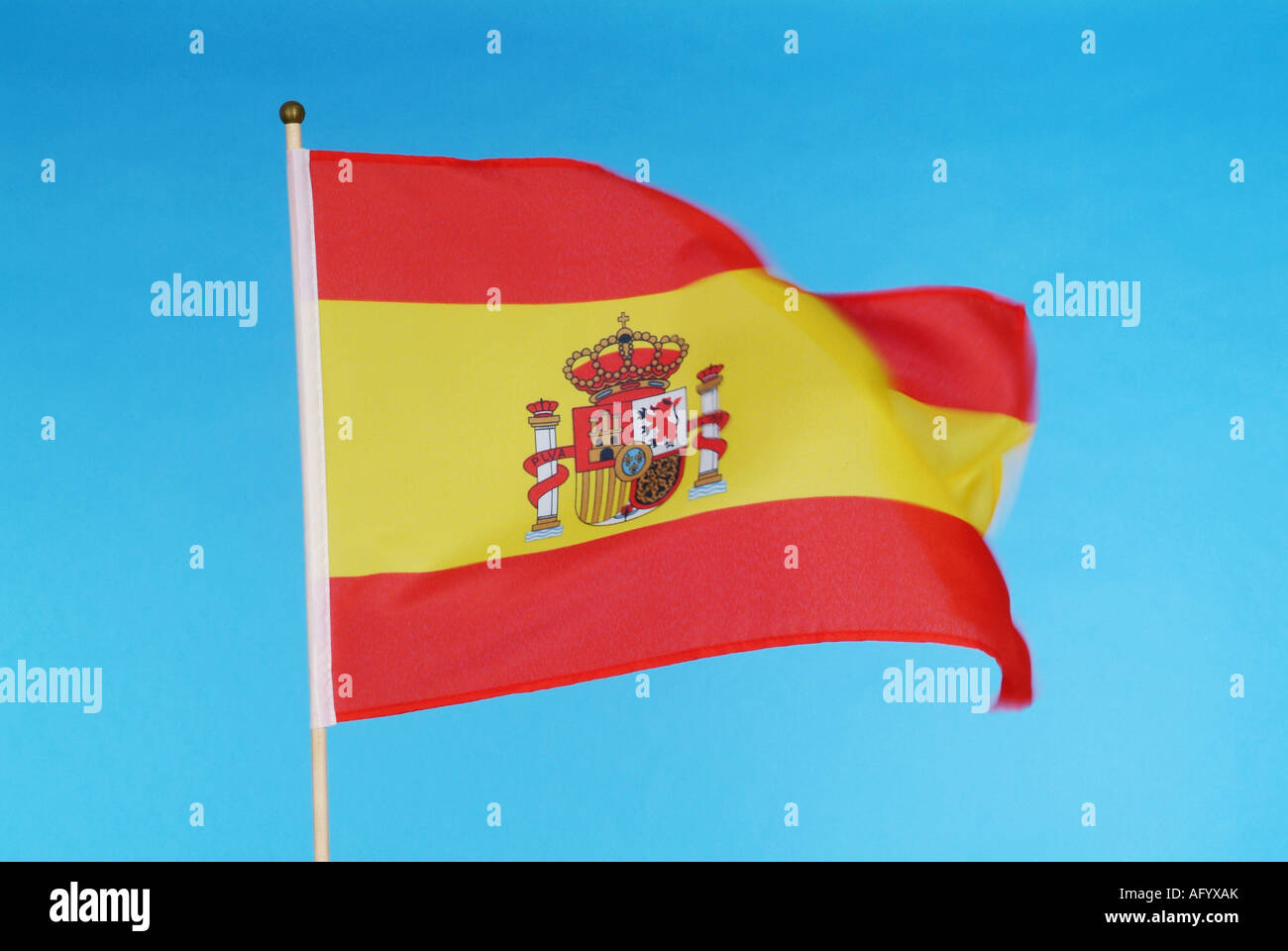 Spanish national flag against blue sky Stock Photo - Alamy