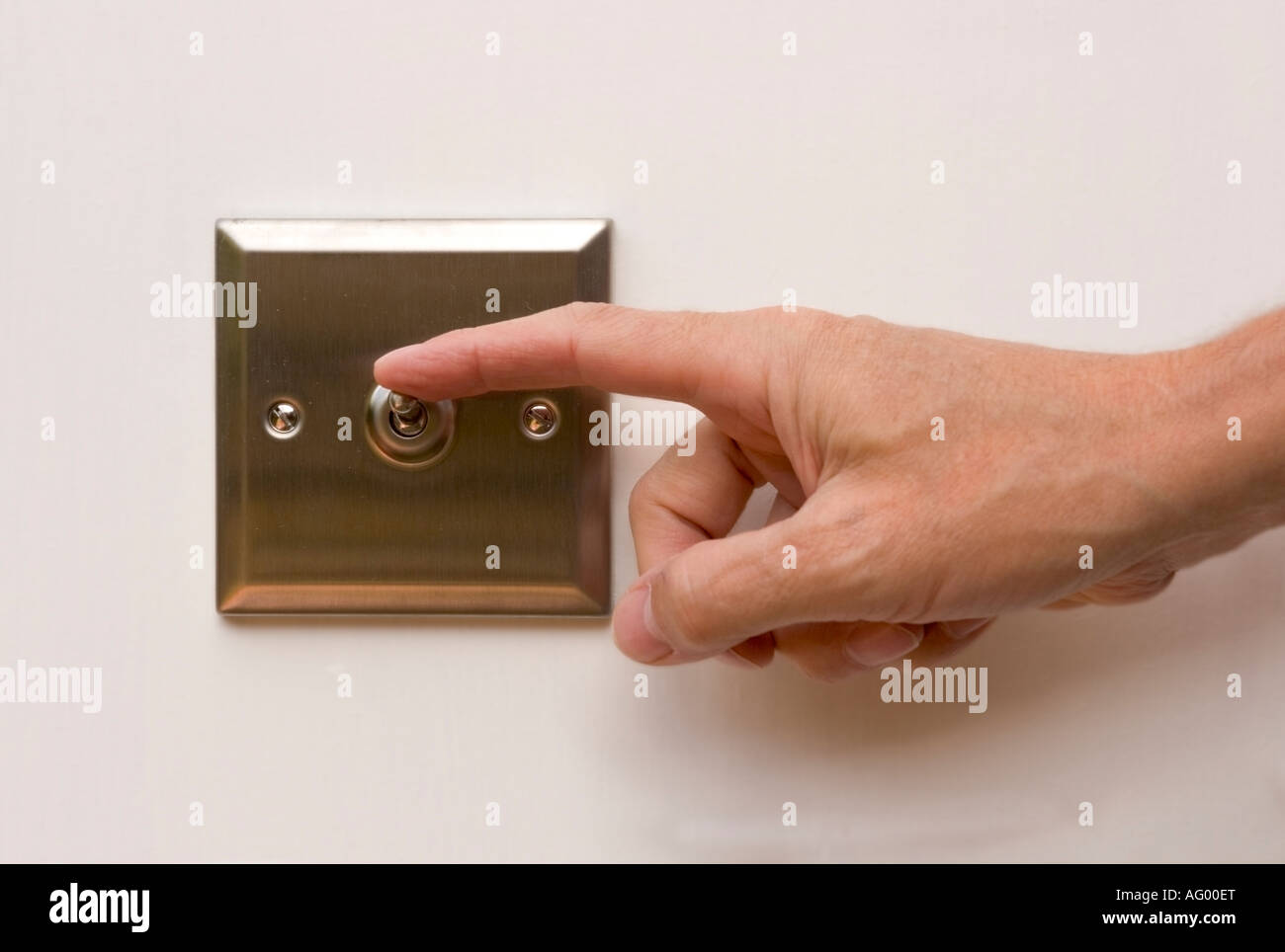 Male hand switching off a wall mounted light switch Stock Photo - Alamy