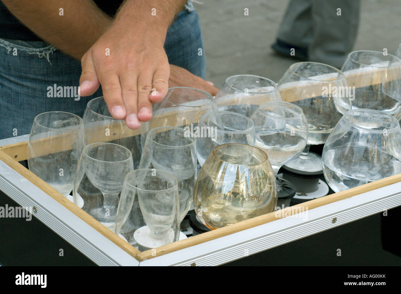 Hands of a man playing a 'glass organ' a reflection of St.Mary's church ...