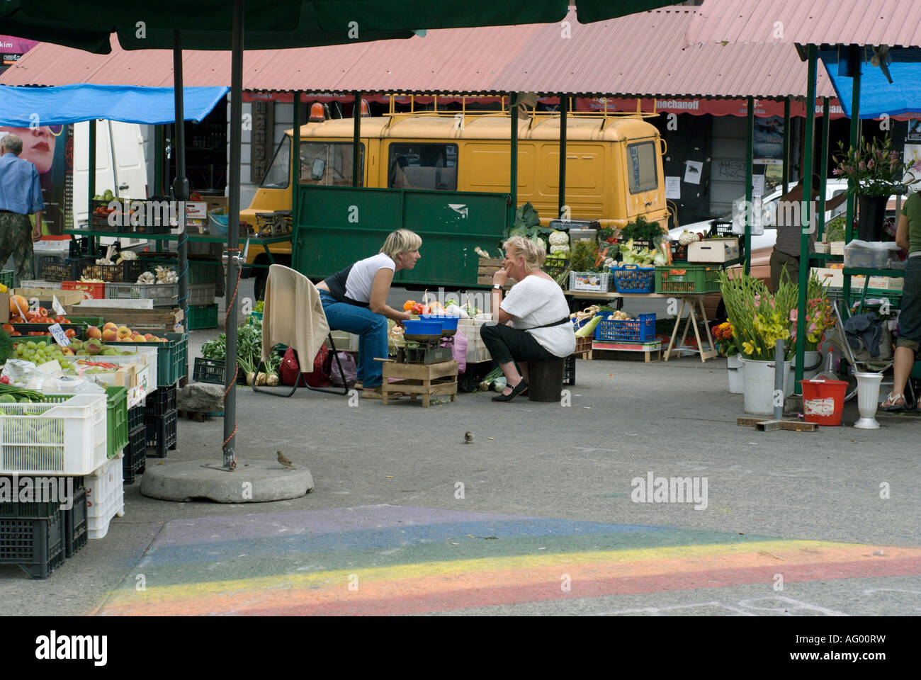 Two Polish woman stall holders talking in a covered fruit and vegetable ...