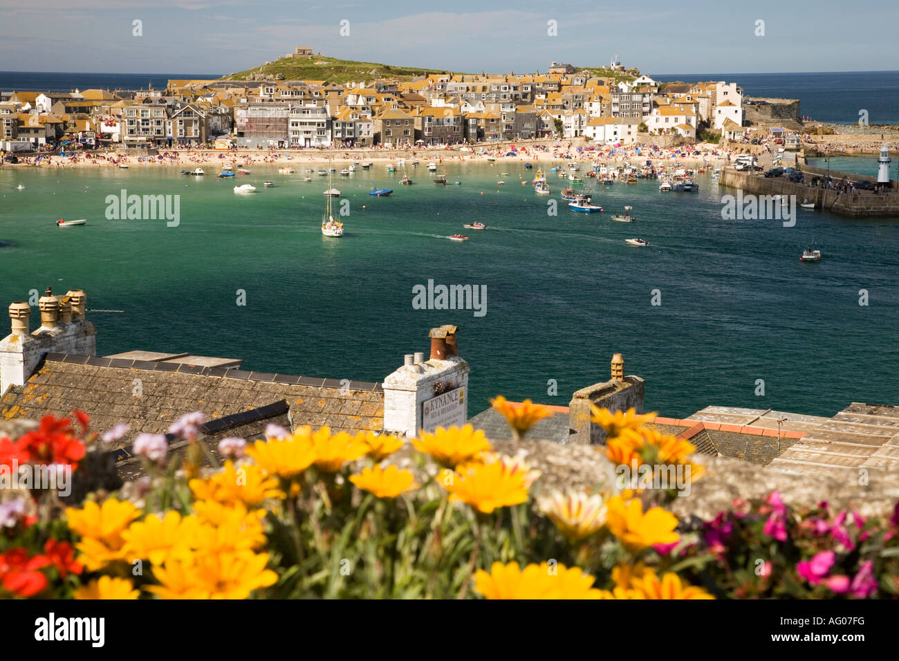 View of yachts in sea with town in background at St Ives in Cornwall ...