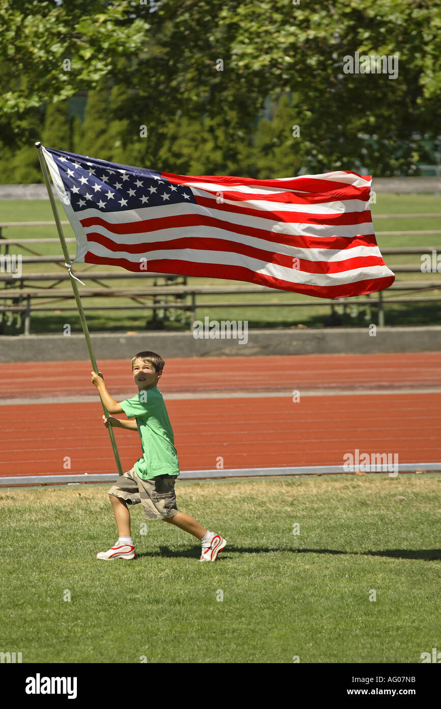 A boy running with a large American flag Stock Photo - Alamy