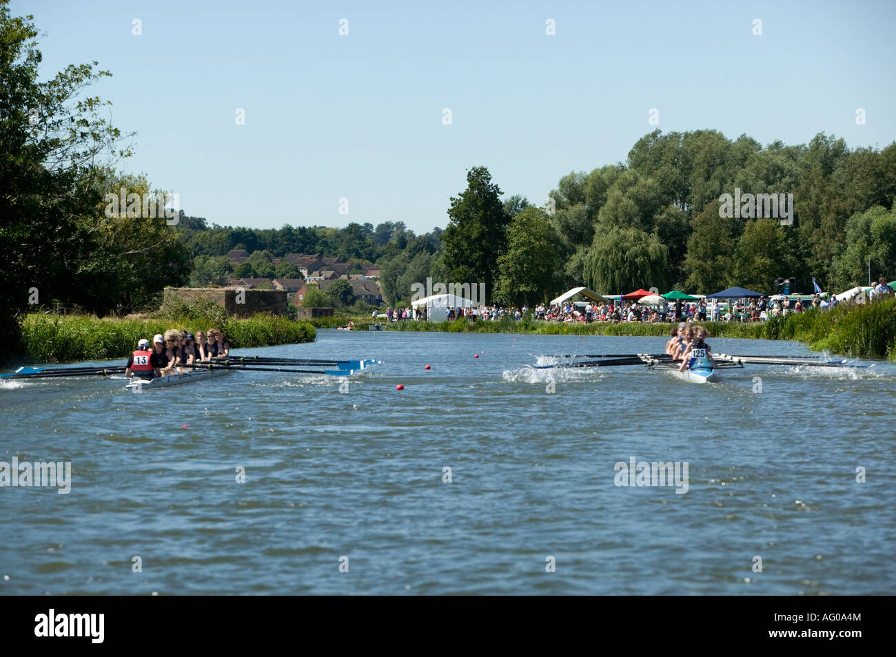 Two crews of female rowers in coxed eights racing in rowing regatta ...