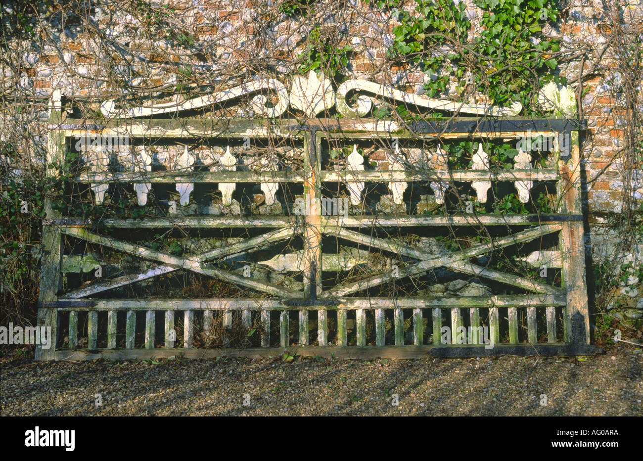 Old Ornate Wooden Gate Leaning Against Brick Wall Stock Photo - Alamy