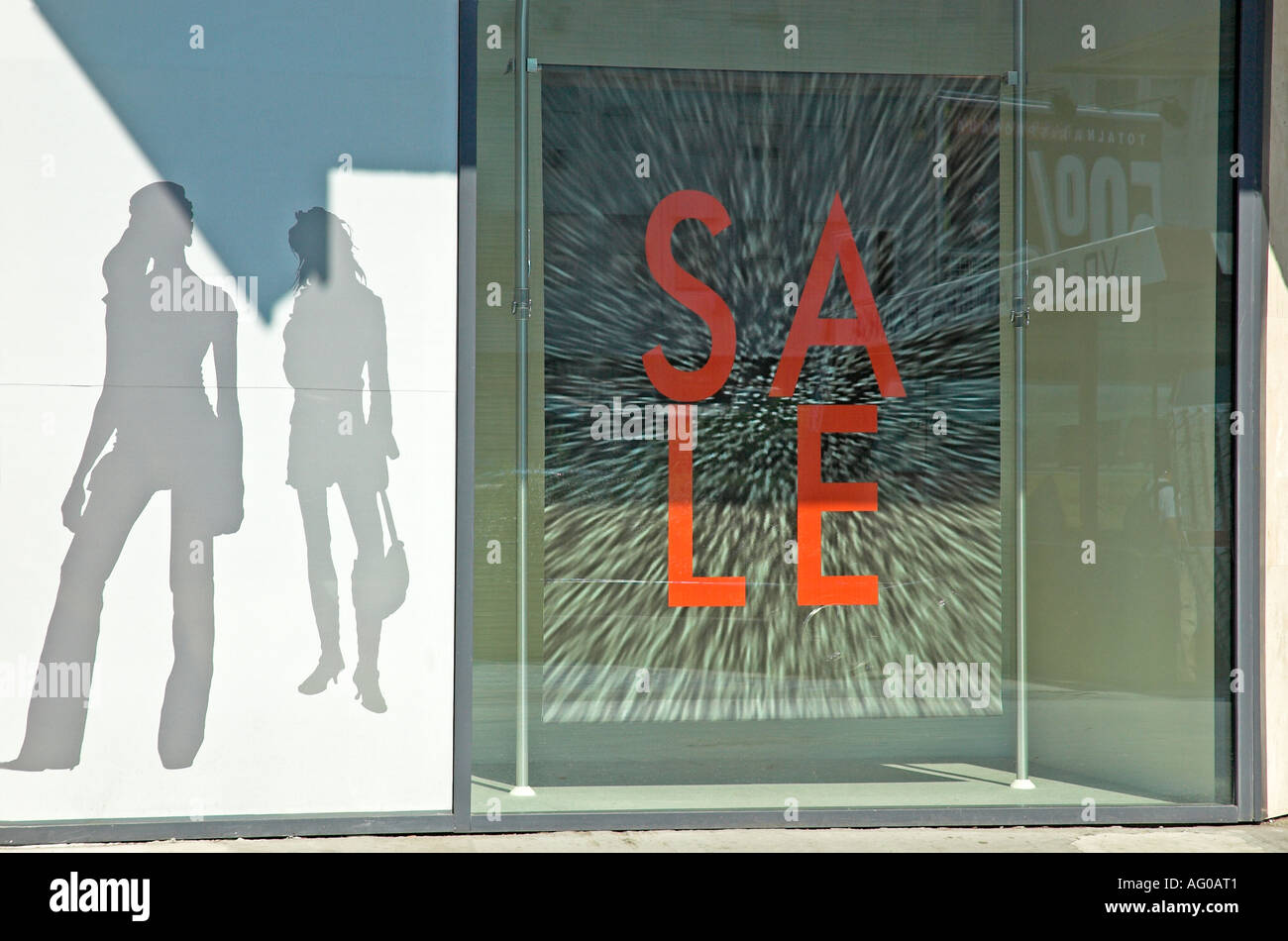 Sale sign inside of clothing store window Stock Photo - Alamy