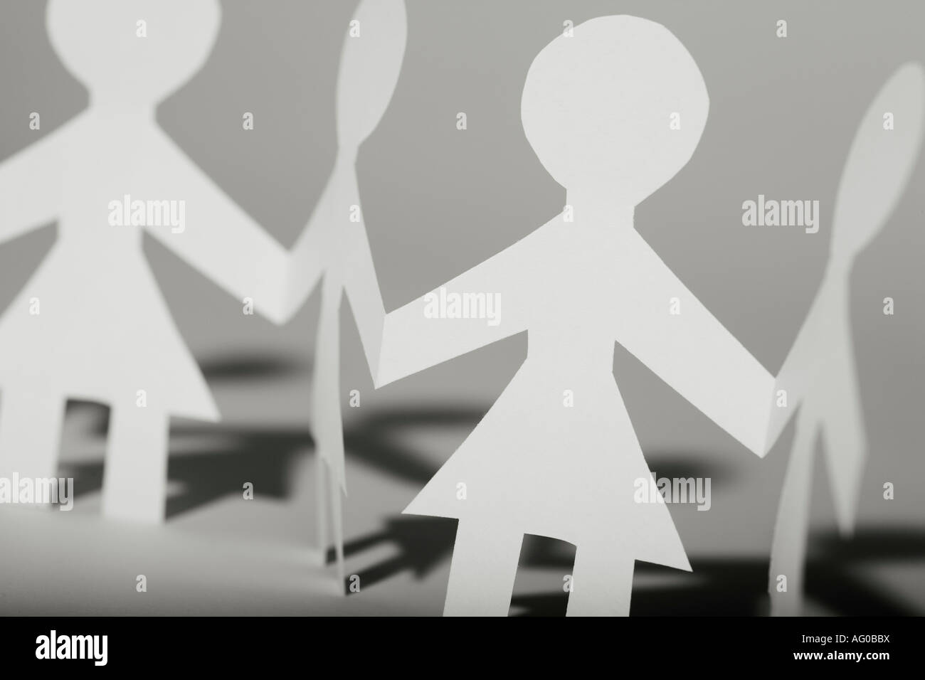 Paper dolls holding hands hi-res stock photography and images - Alamy