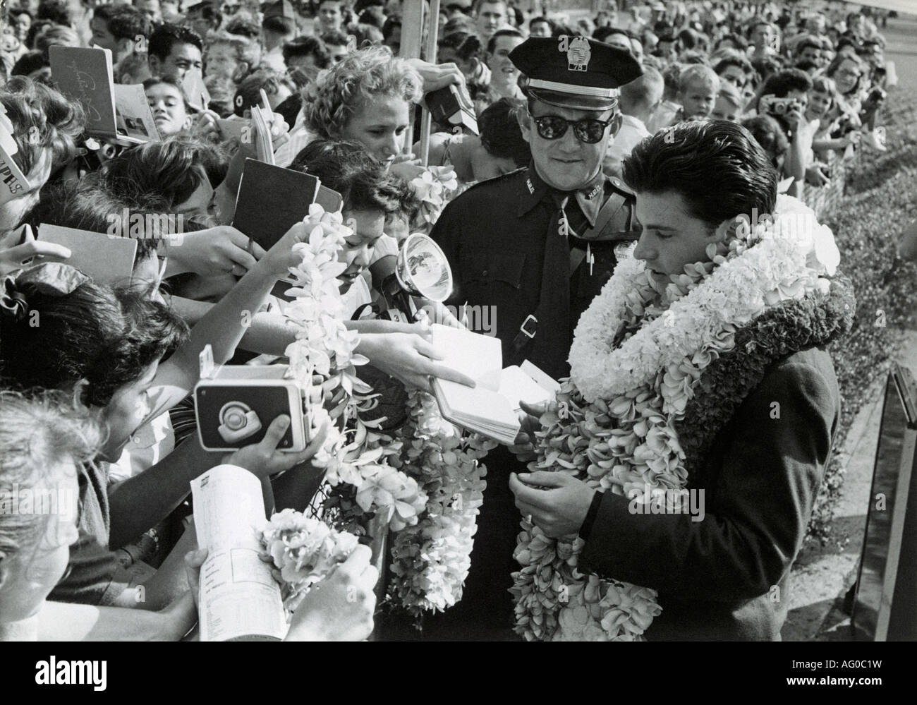 RICKY NELSON - US pop singer signs for fans about 1963 Stock Photo - Alamy