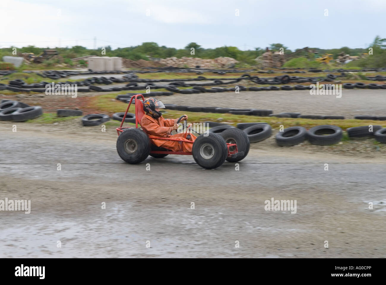 Cross cart driving on a ground track with tires as fence Stock Photo ...