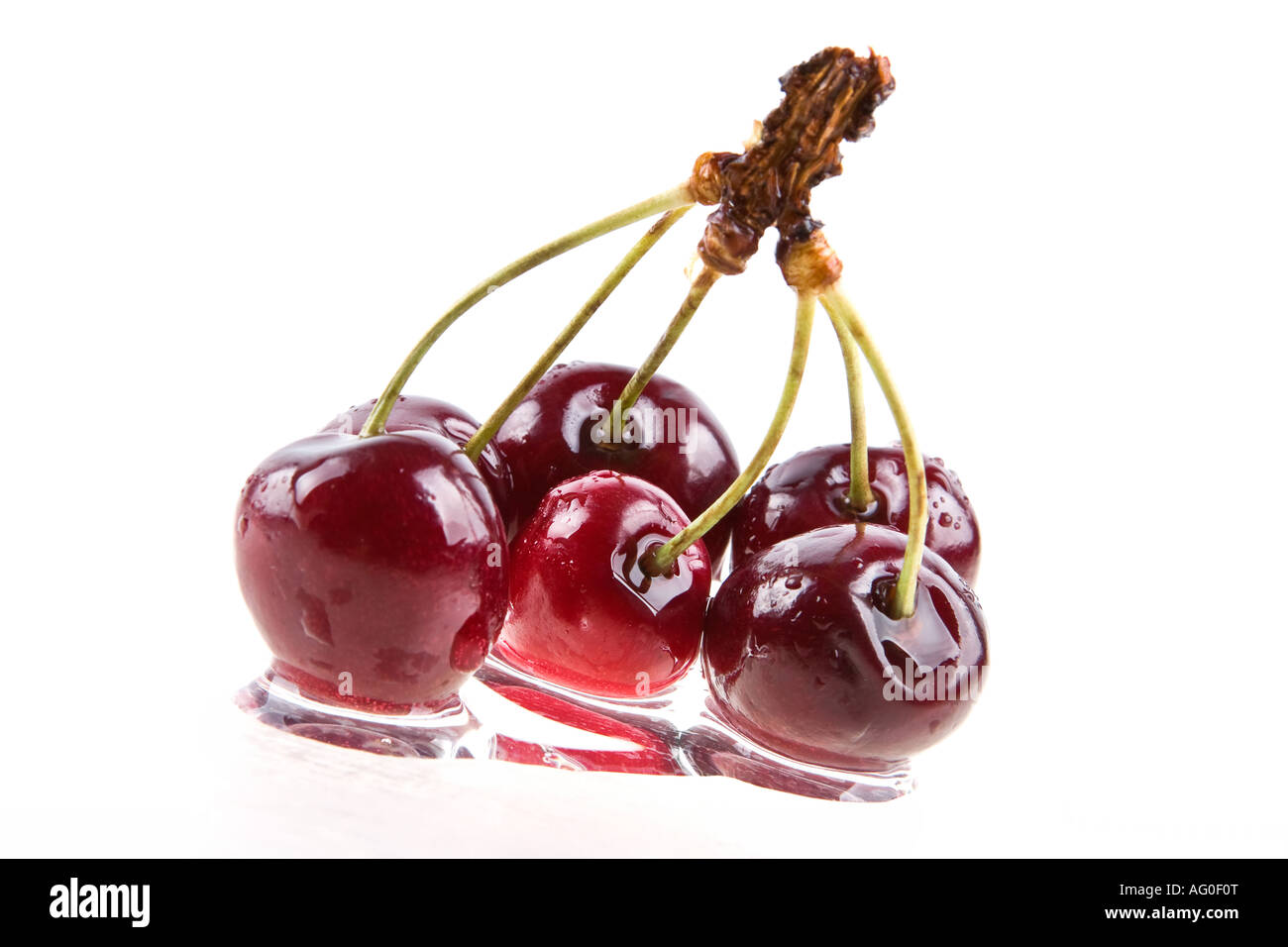 Cooled sweet cherries in drops of waters shined from below Stock Photo ...