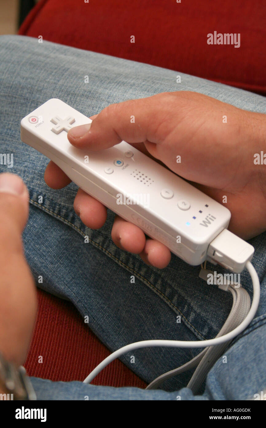 white male hands holding Nintendo Wii remote control Stock Photo - Alamy
