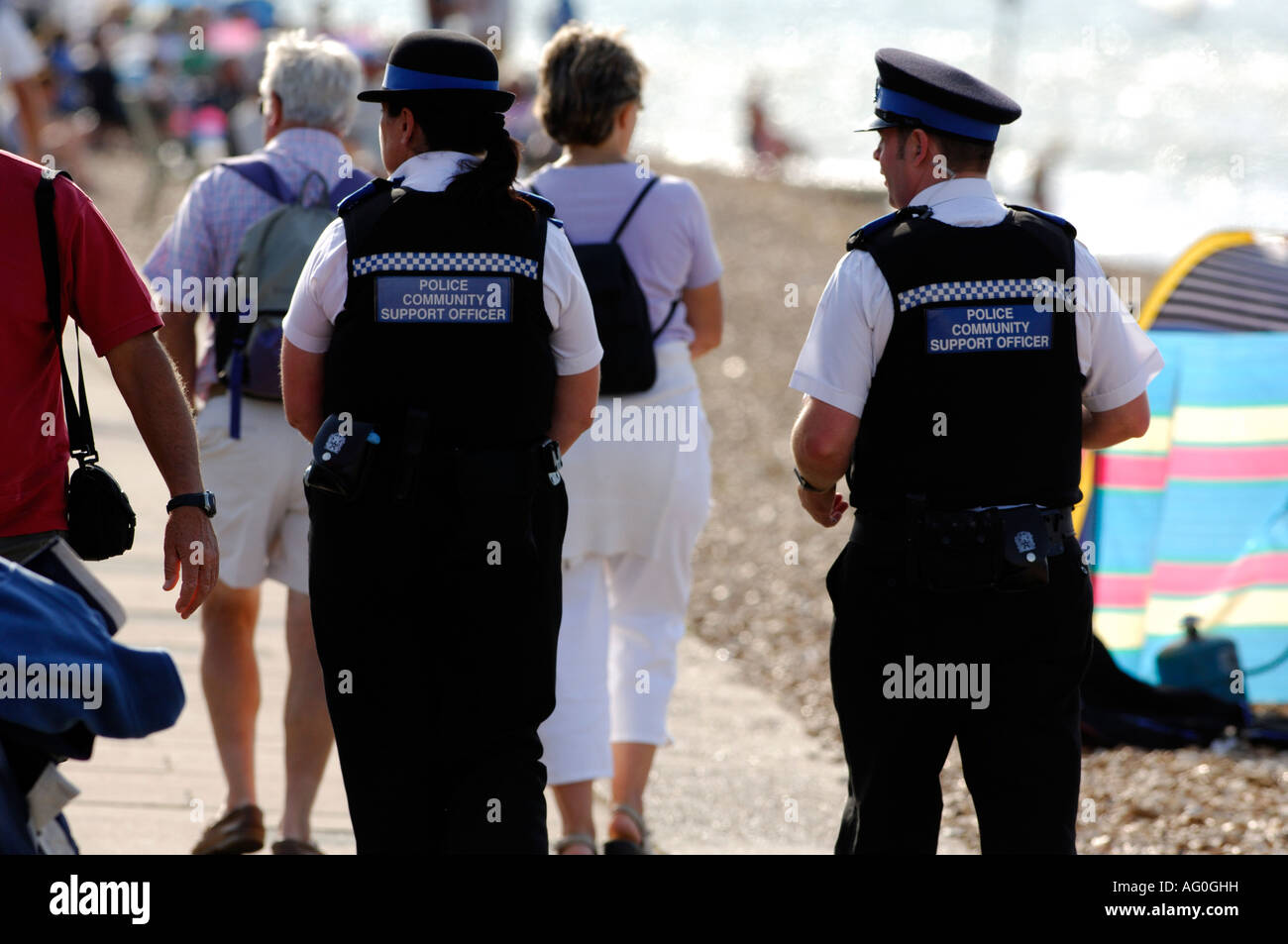 two 2 police community support officers patrolling amongst crowds ...
