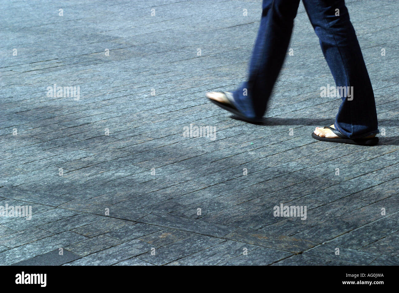 Person Walking on a pavement in New York City Stock Photo - Alamy