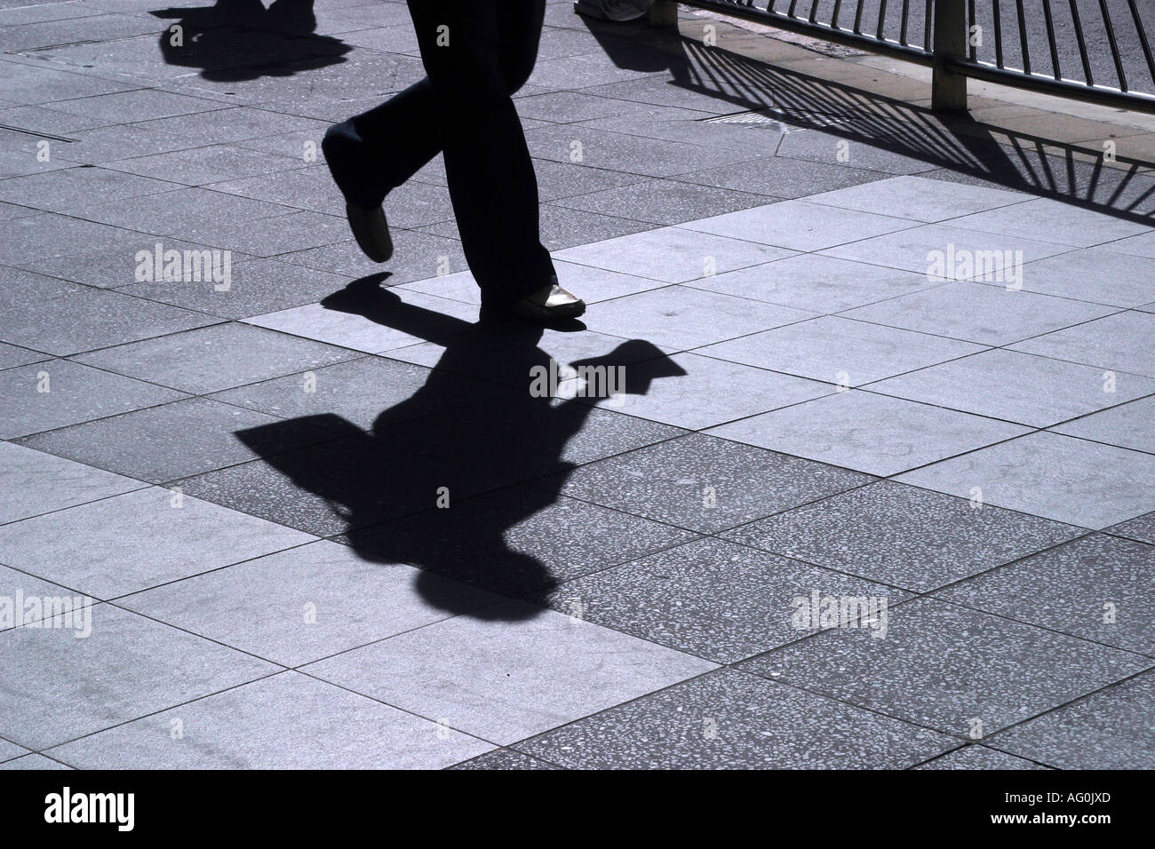 Man walking on paving slabs hi-res stock photography and images - Alamy