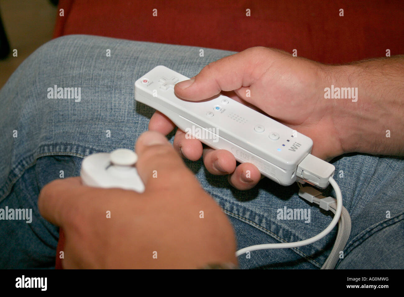 white male hands holding Nintendo Wii remote control Stock Photo - Alamy