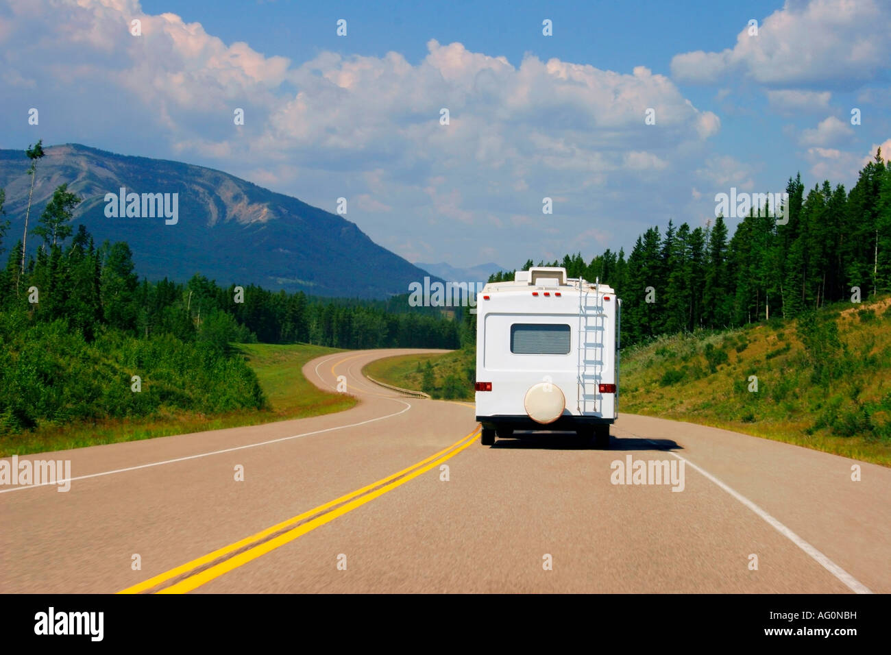 Recreational vehicle driving through the mountains Stock Photo - Alamy