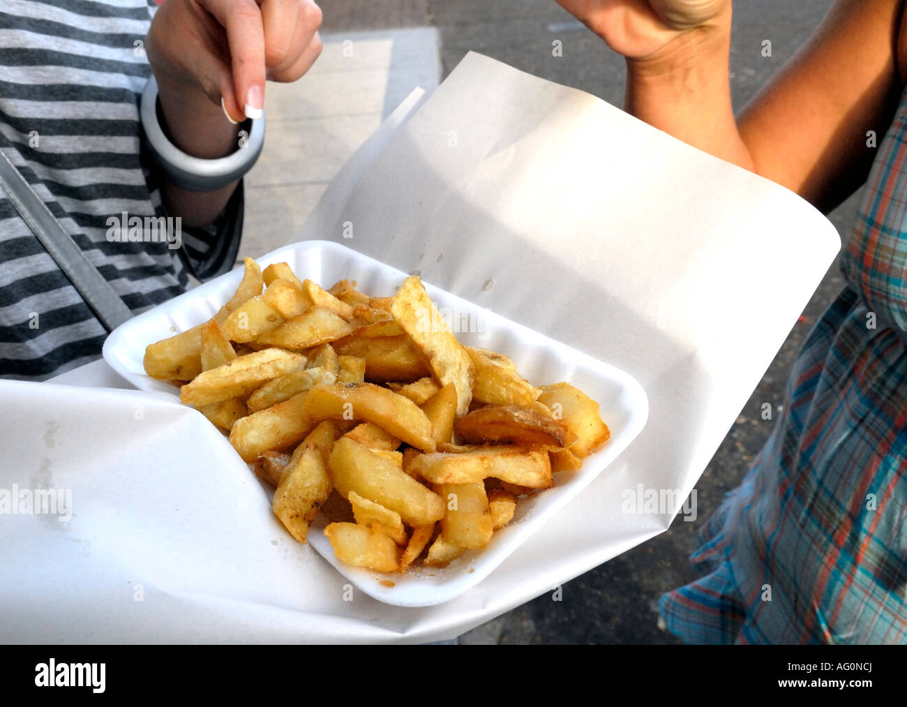 Woman Eating a Portion of Chips Stock Photo - Alamy