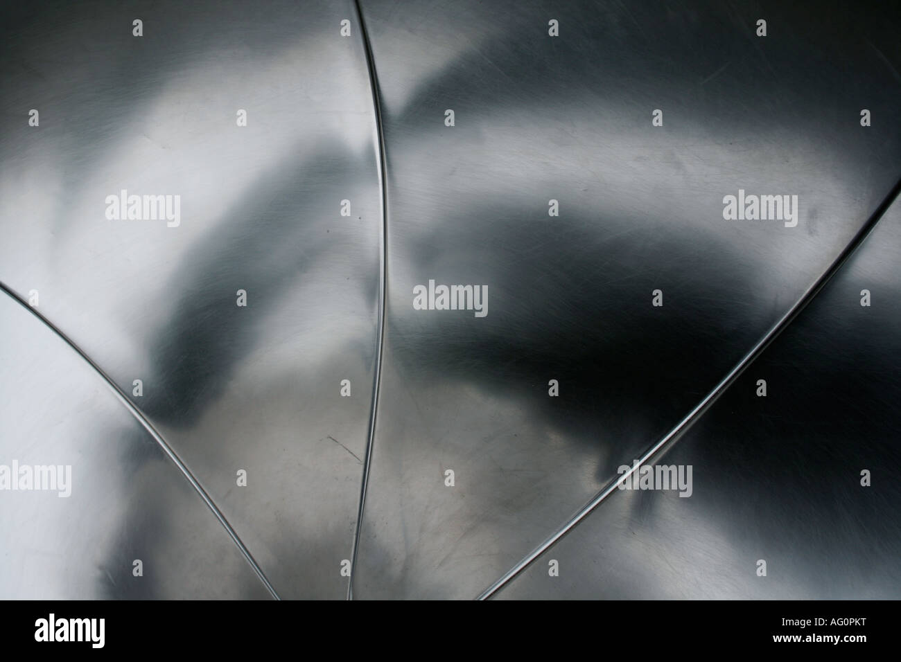 Stainless steel slide close up with light reflections and curved lines ...