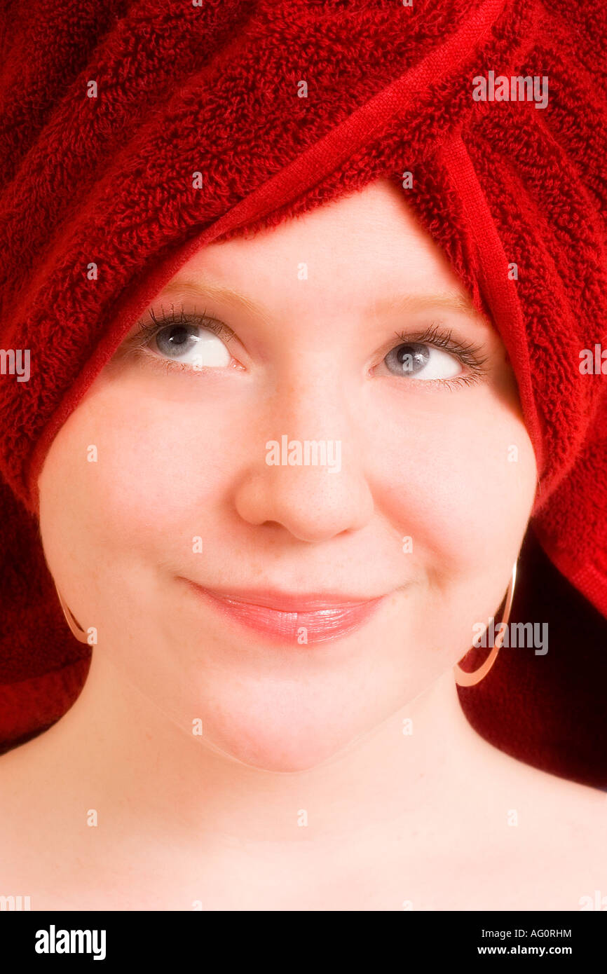 Young woman with hair wrapped in red towel Stock Photo - Alamy