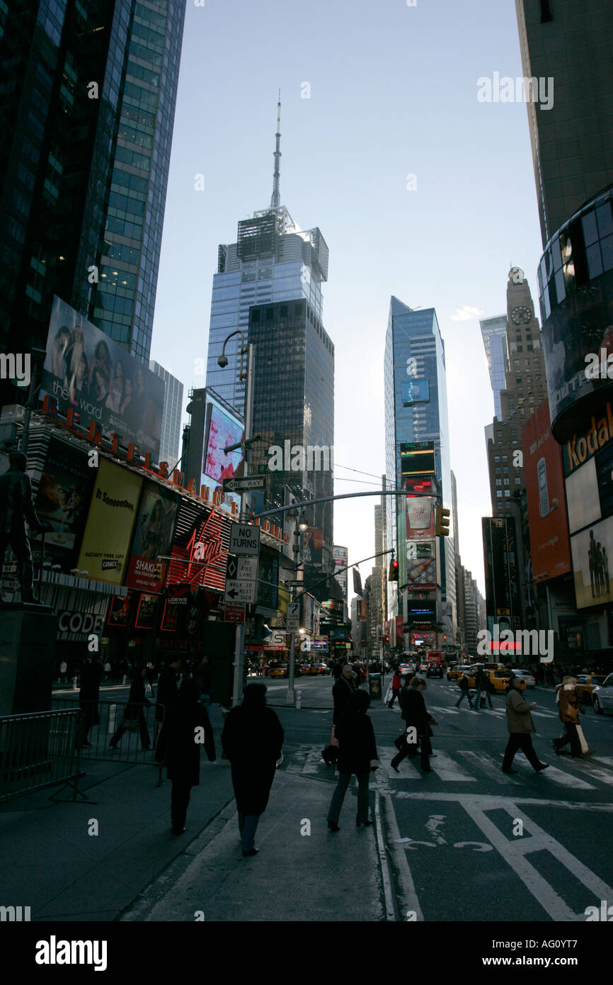 tourists walk across cross walk times square in daytime new york city ...