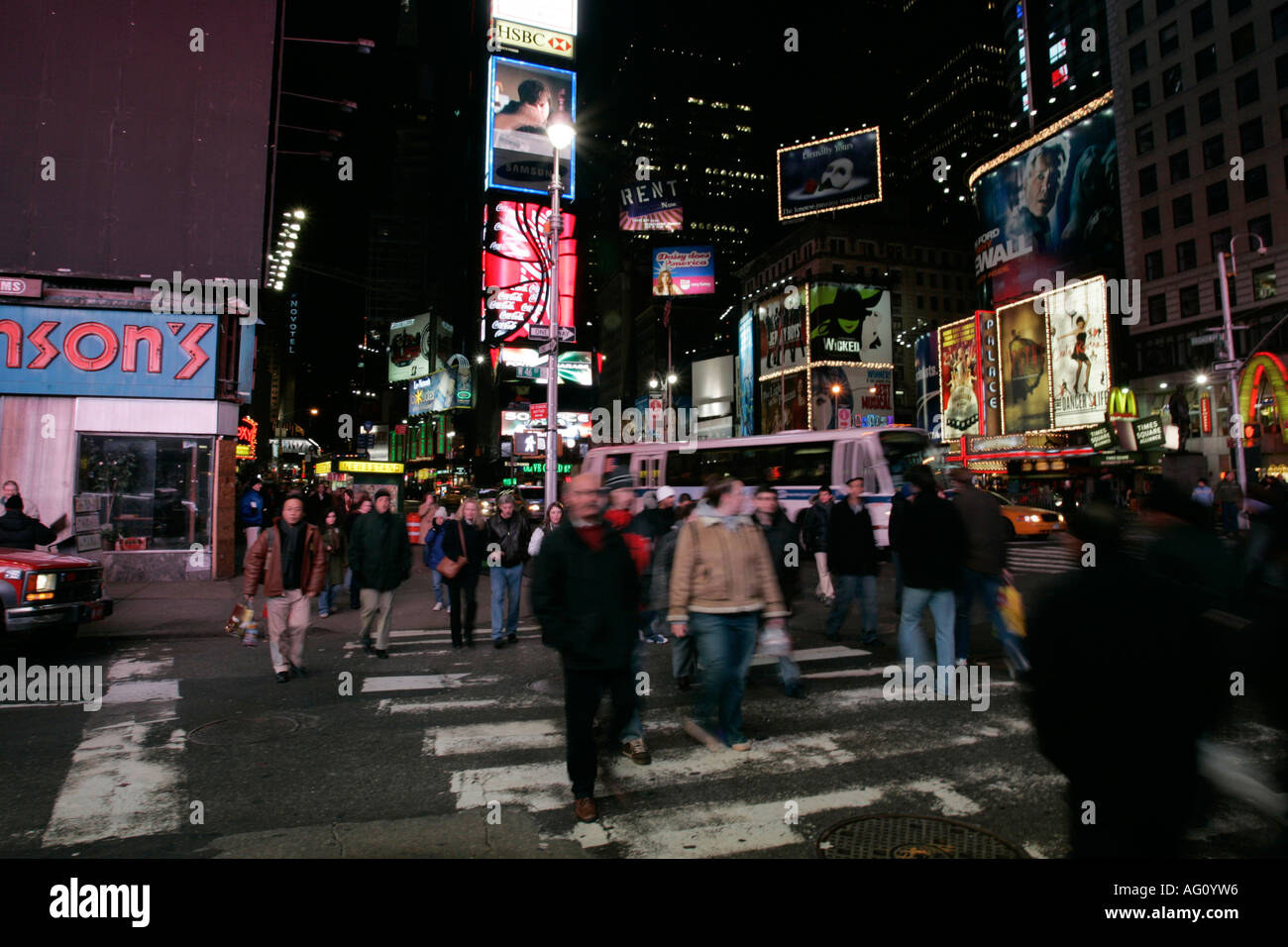pedestrians crossing crosswalk in times square in nighttime new york ...