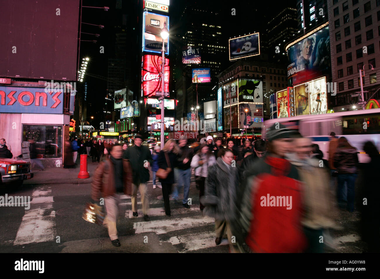 pedestrians crossing crosswalk in times square in nighttime new york ...