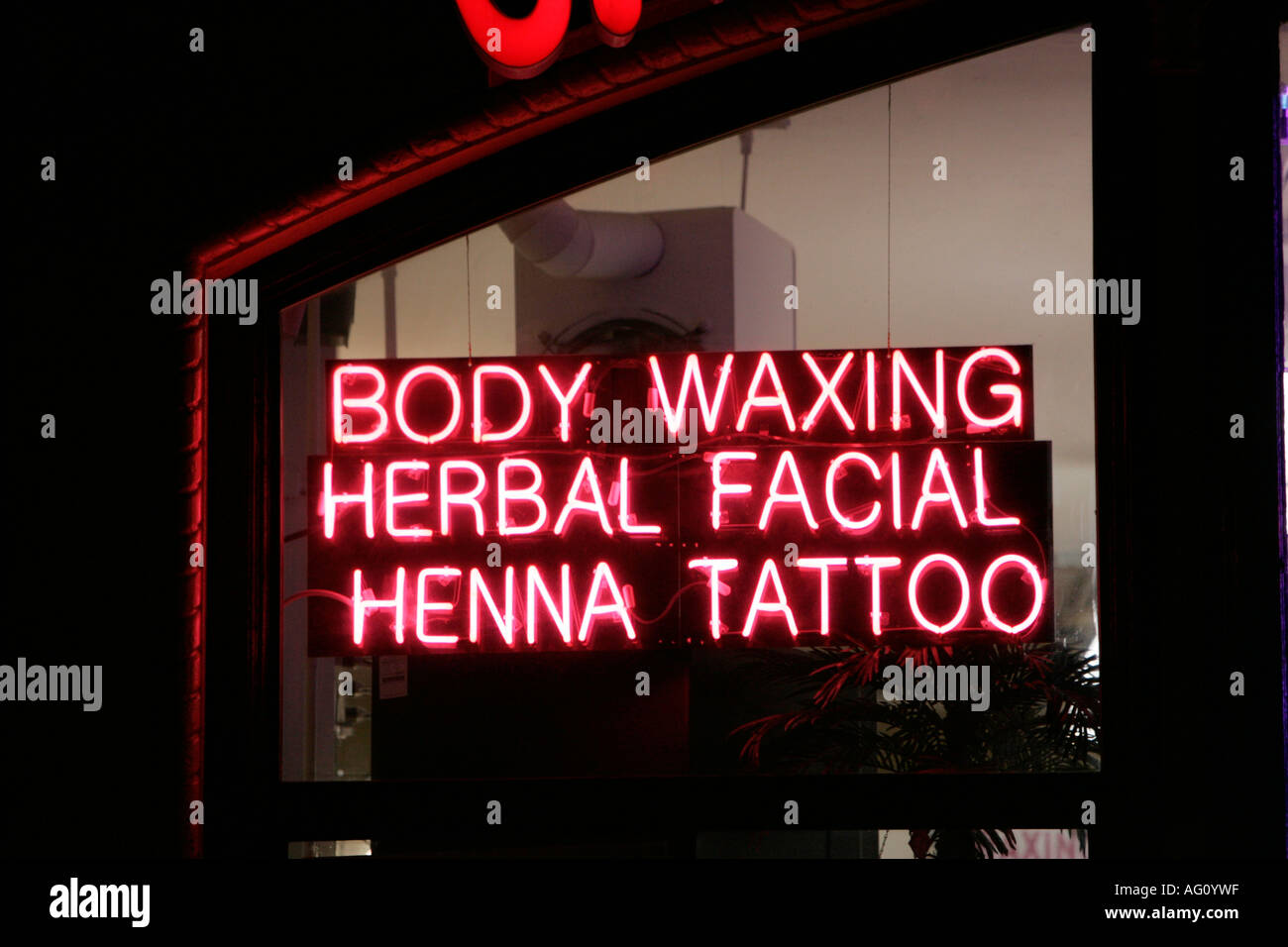 body waxing herbal facial henna and tattoo pink neon signs in a shop ...