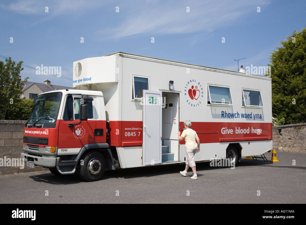 Senior woman entering mobile welsh National Blood Service vehicle ...