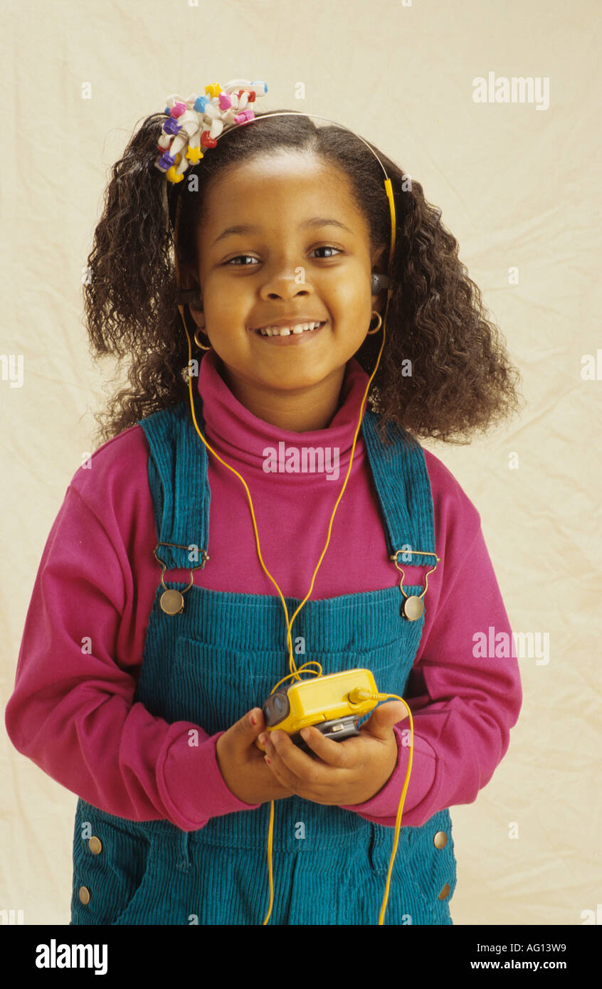 Hip little girl listening to music Stock Photo - Alamy