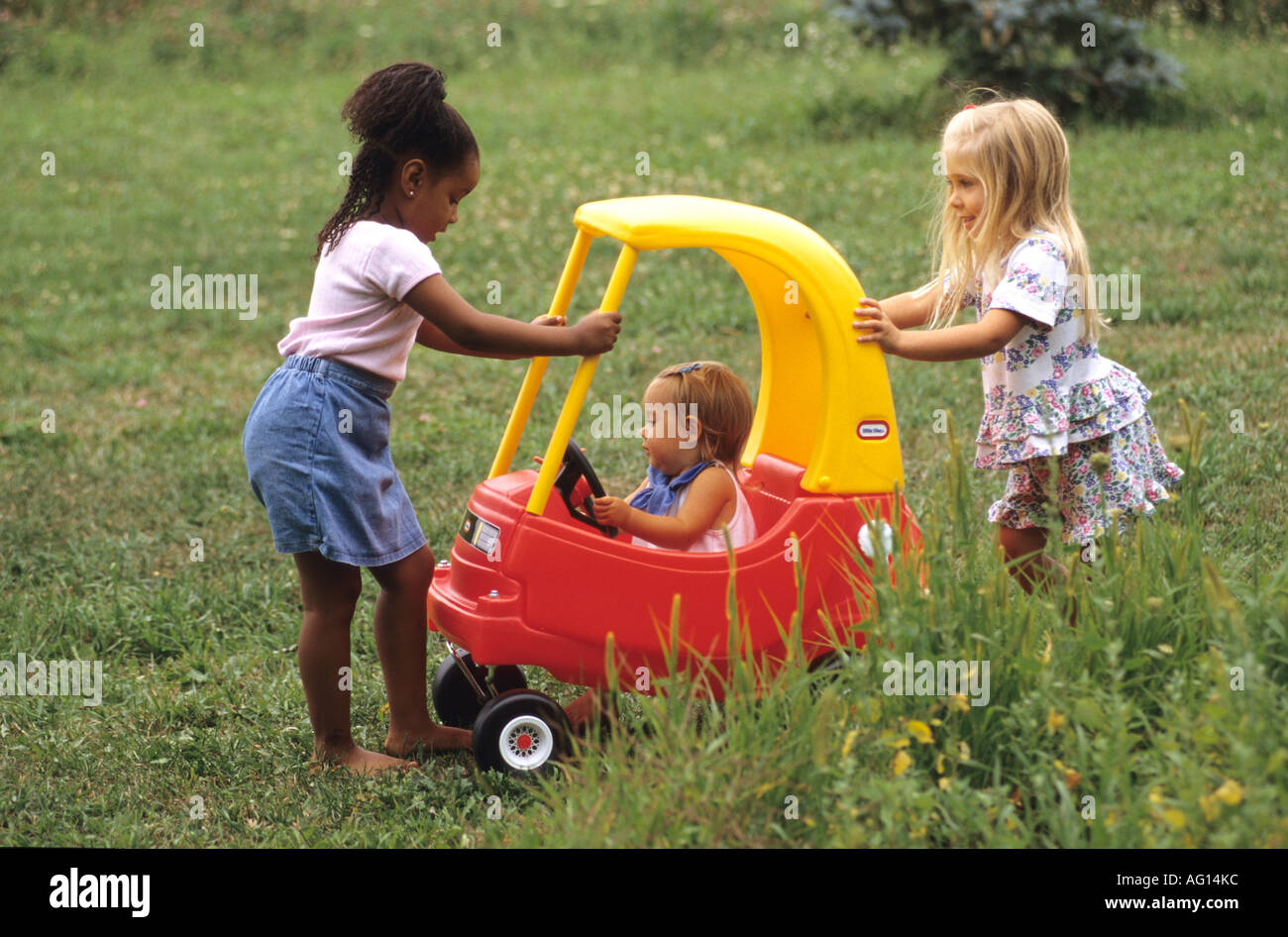 Three girls with cart Stock Photo - Alamy
