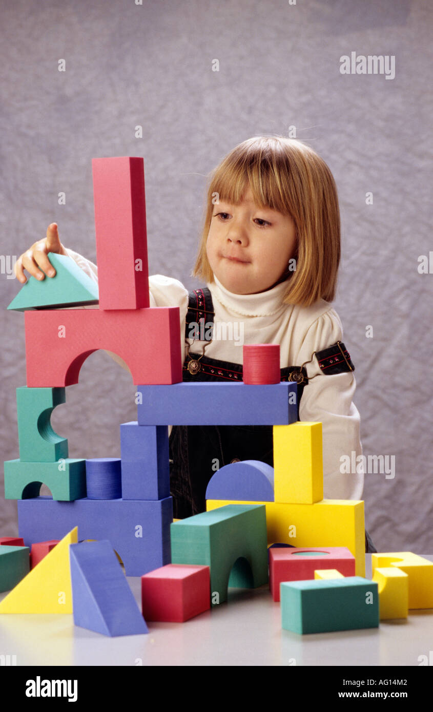 Little girl with building blocks Stock Photo - Alamy
