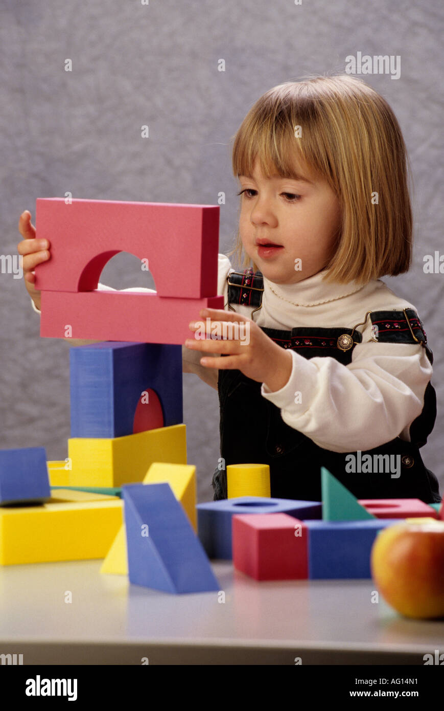 Little girl with building blocks Stock Photo - Alamy