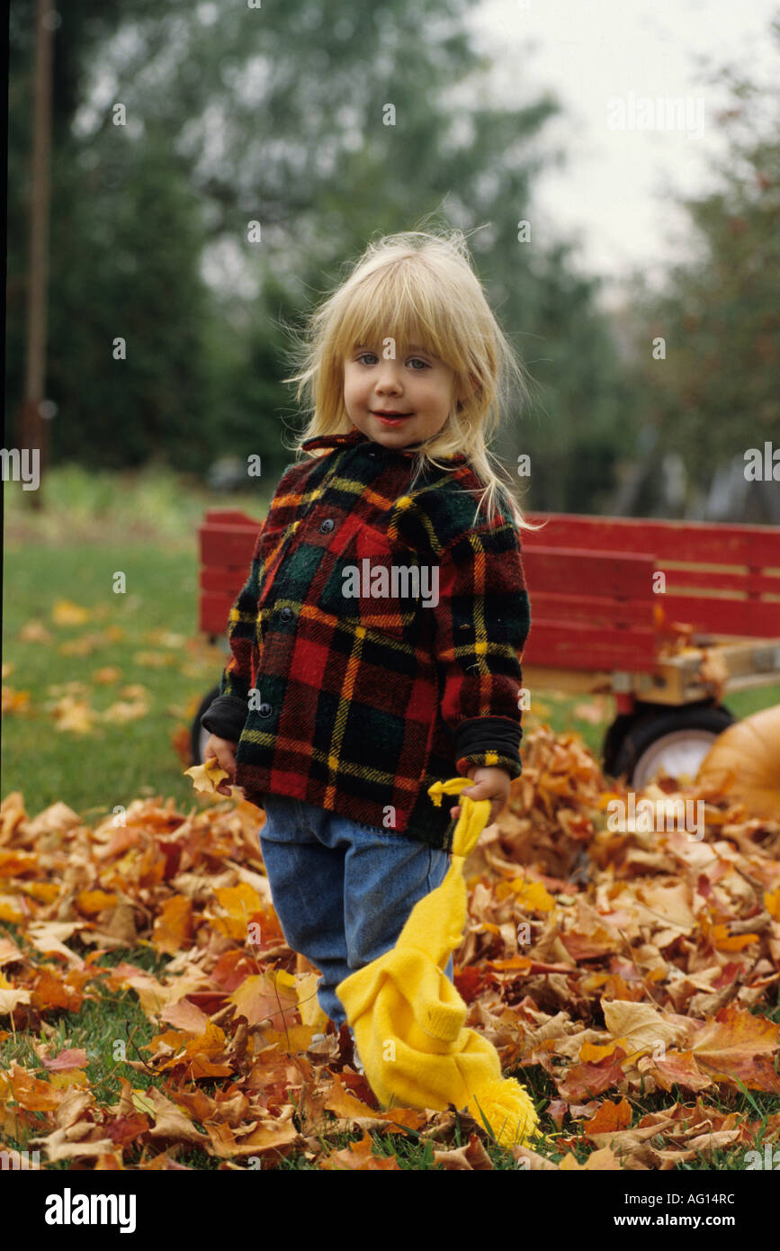 Little girl in autumn setting Stock Photo - Alamy