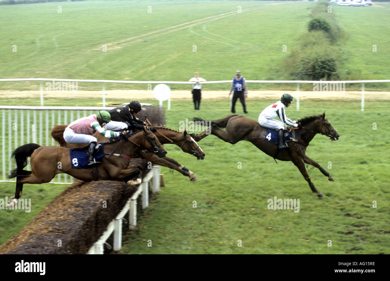 Horses jumping in steeplechase race at Stratford Races, Warwickshire ...