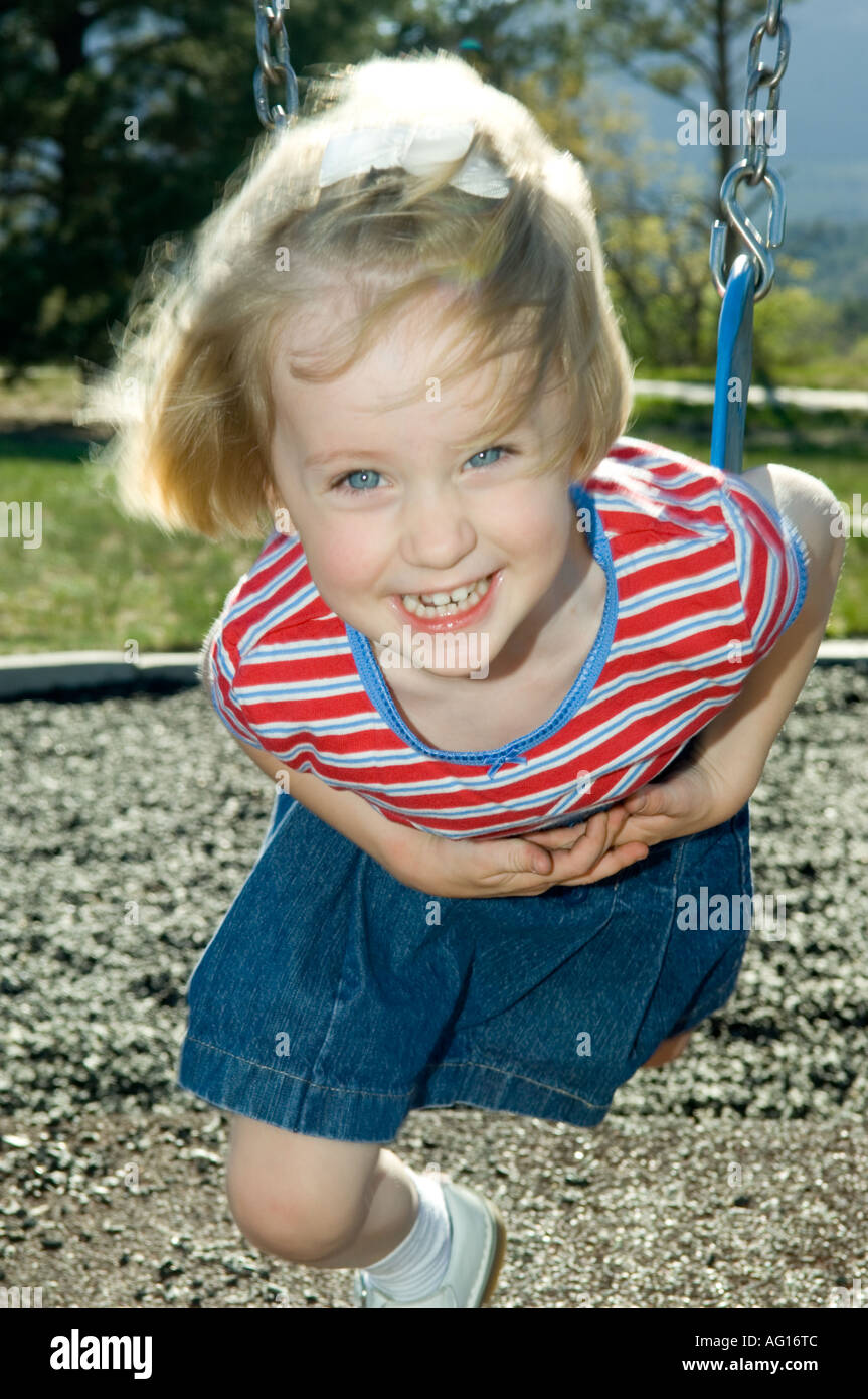 Girls Laying on Swing Stock Photo - Alamy
