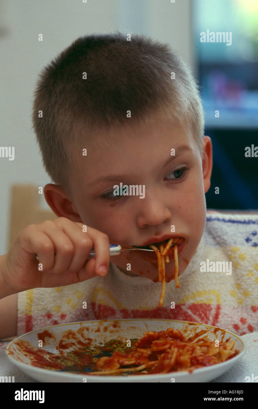 Boy is eating spaghetti Stock Photo - Alamy