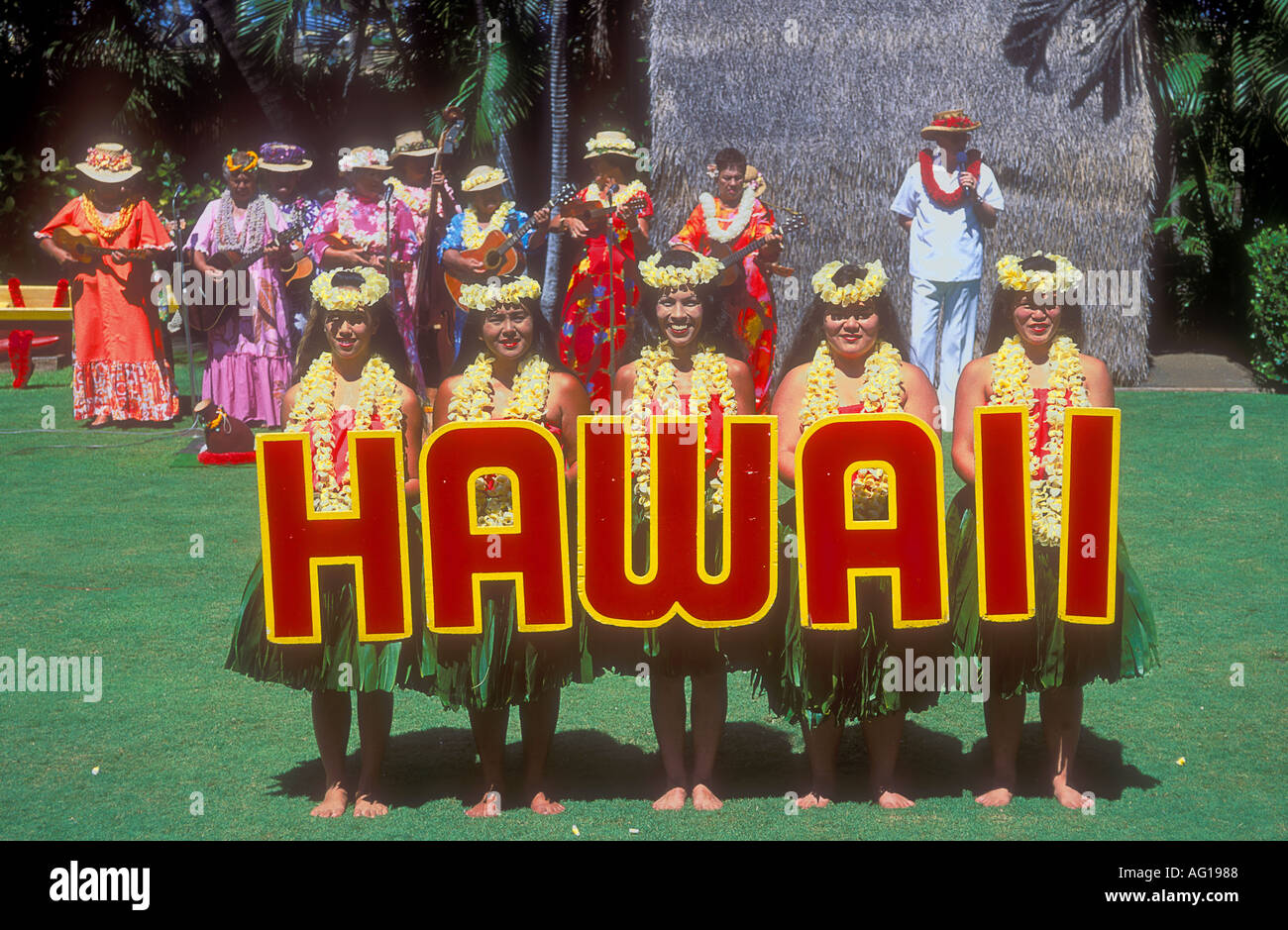 Dancers near Waikiki Beach holding a Hawaii sign Oahu Hawaii USA Stock ...