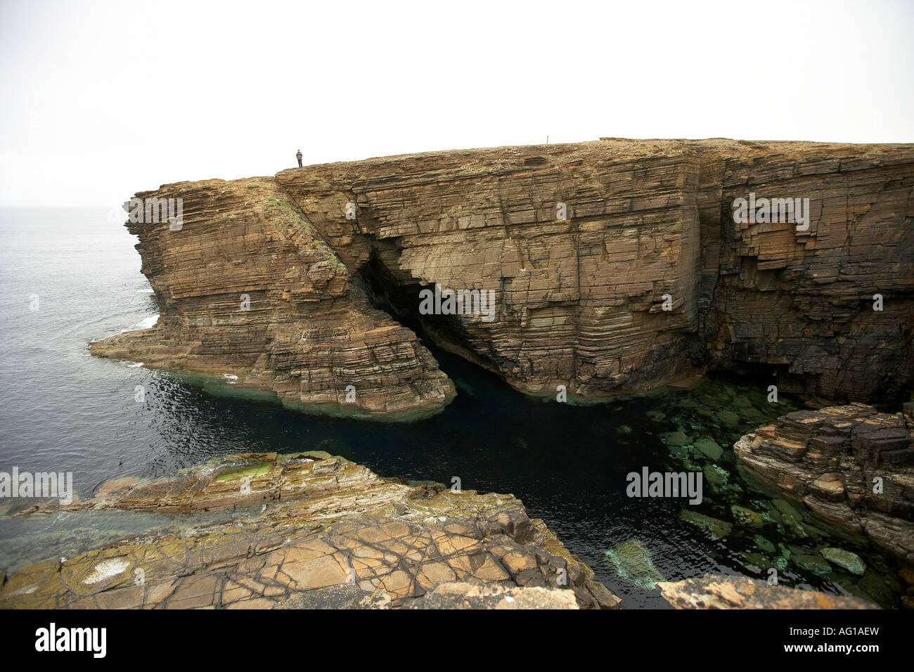 Figure on Natural arch Garthna Geo bay Yesnaby Orkney Scotland UK Stock ...