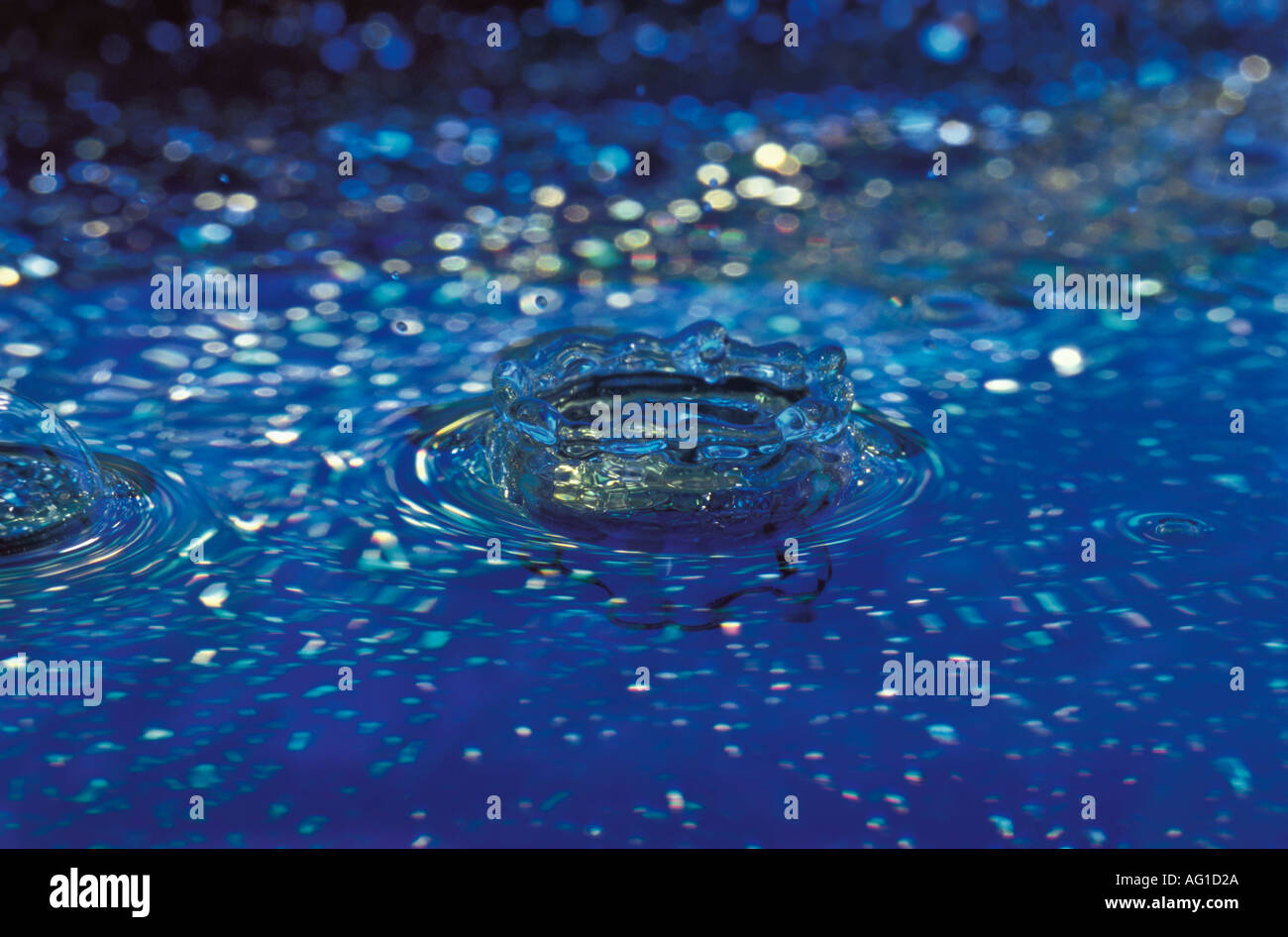 WATER DROPLET SPLASHING INTO WATER Stock Photo - Alamy
