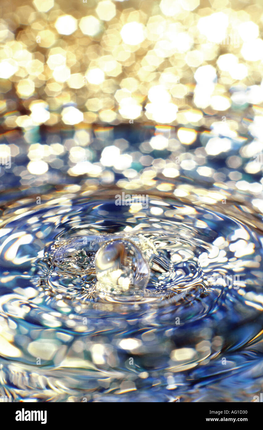 WATER DROPLET SPLASHING INTO WATER Stock Photo - Alamy
