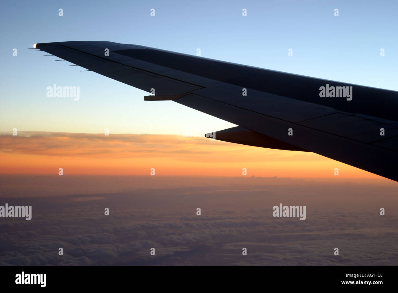 Airplane wing in flight during sunrise Stock Photo - Alamy