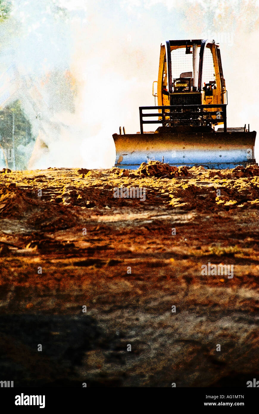 Bulldozer straight on over red dirt Stock Photo - Alamy