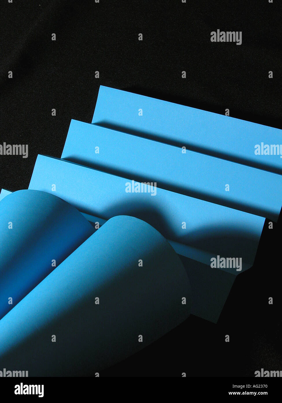 Blue folded paper curves and lines Stock Photo - Alamy