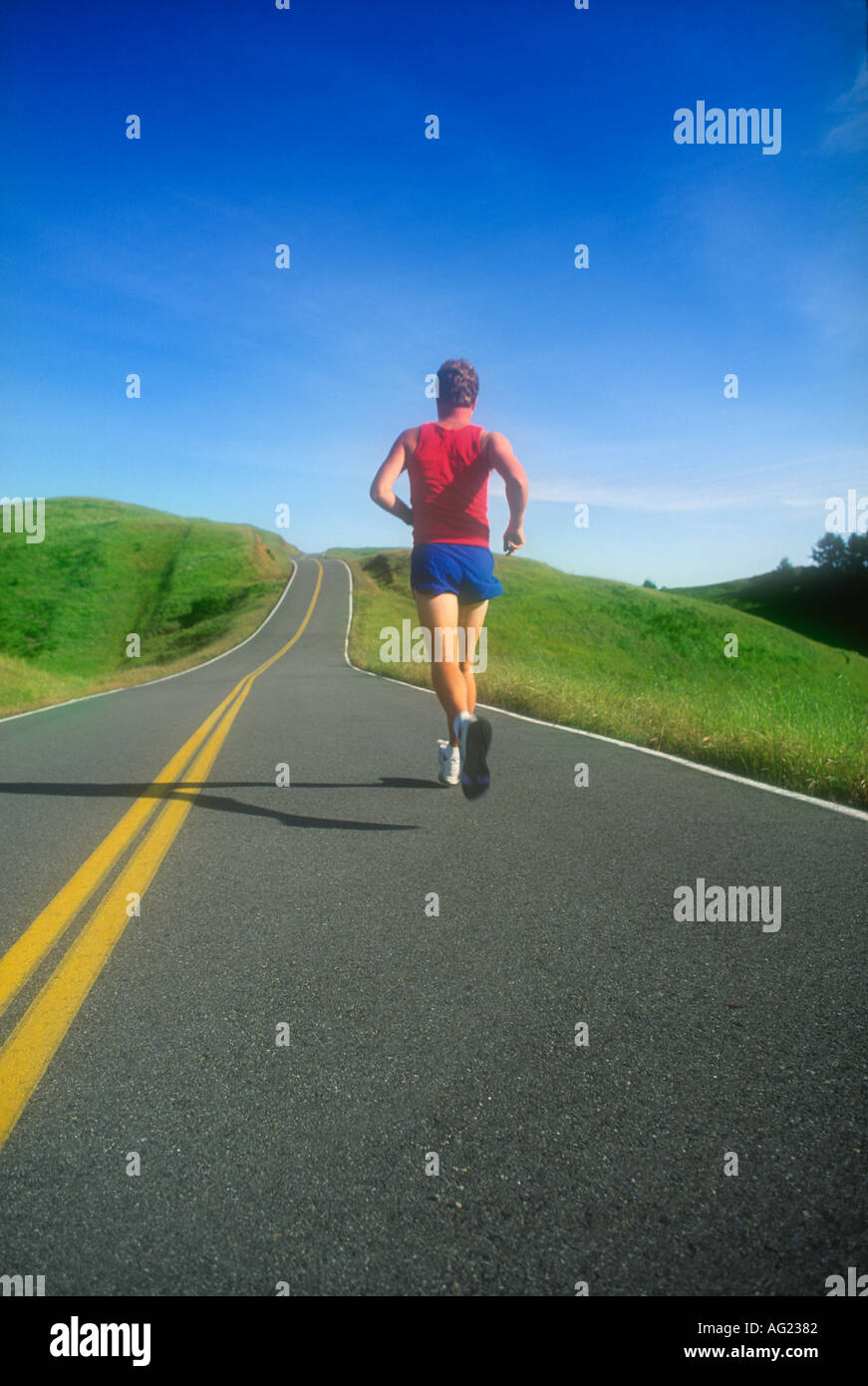 Lonely runner on road hi-res stock photography and images - Alamy